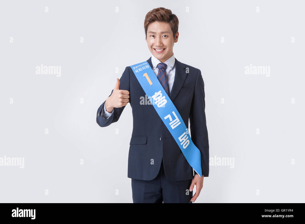 Smiling candidate in suit pointing up Stock Photo - Alamy