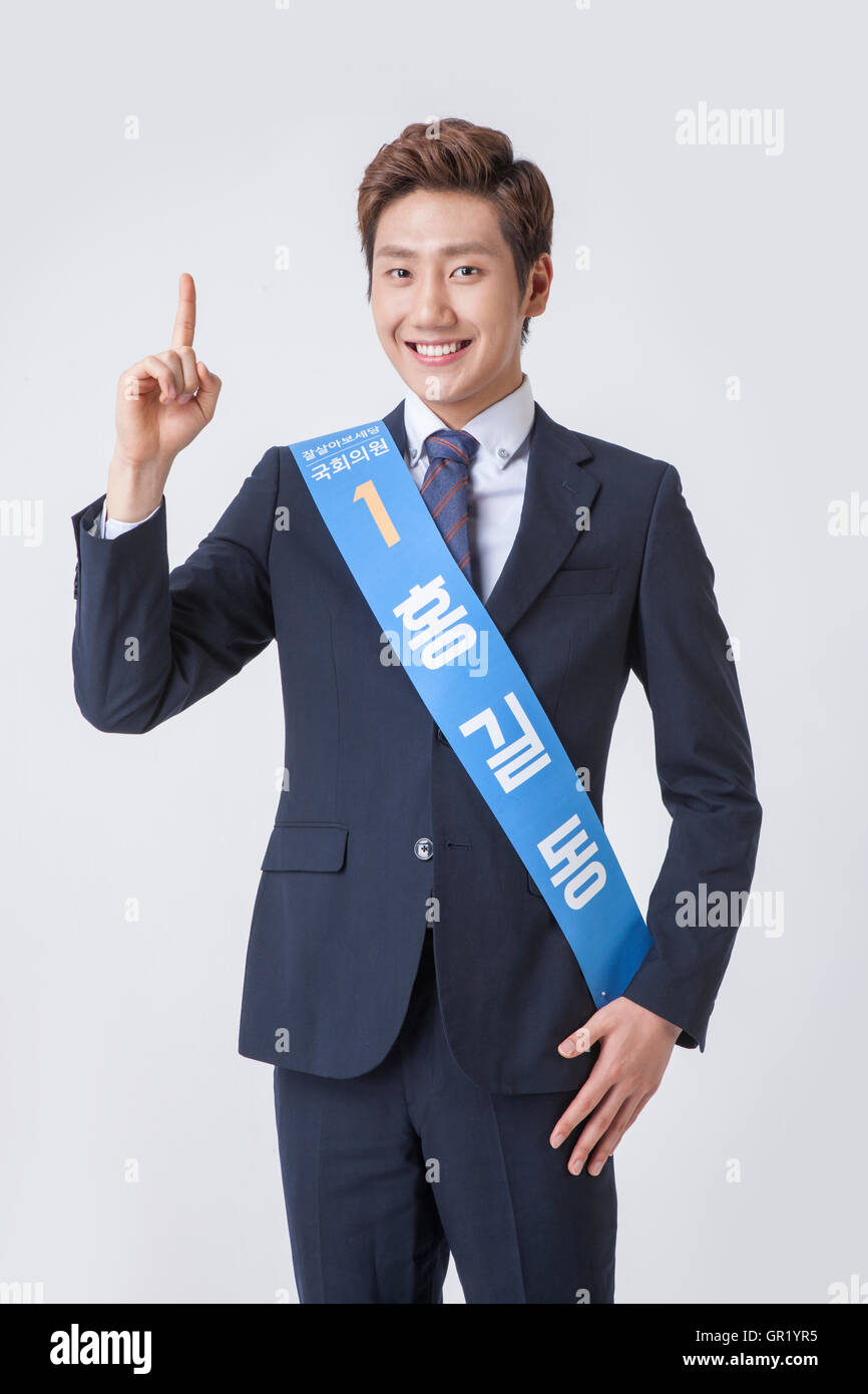 Smiling candidate in suit pointing up Stock Photo - Alamy