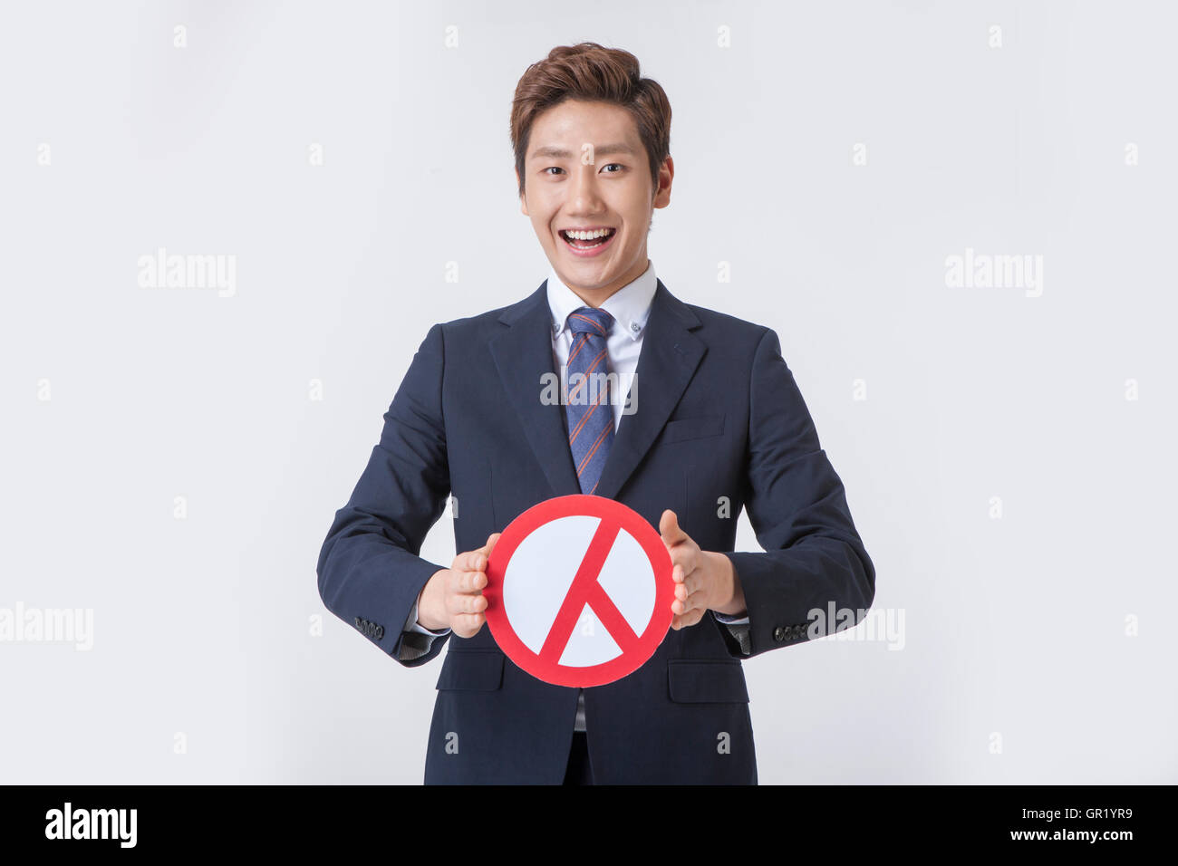 Portrait of young smiling man in suit showing symbol of voting Stock ...