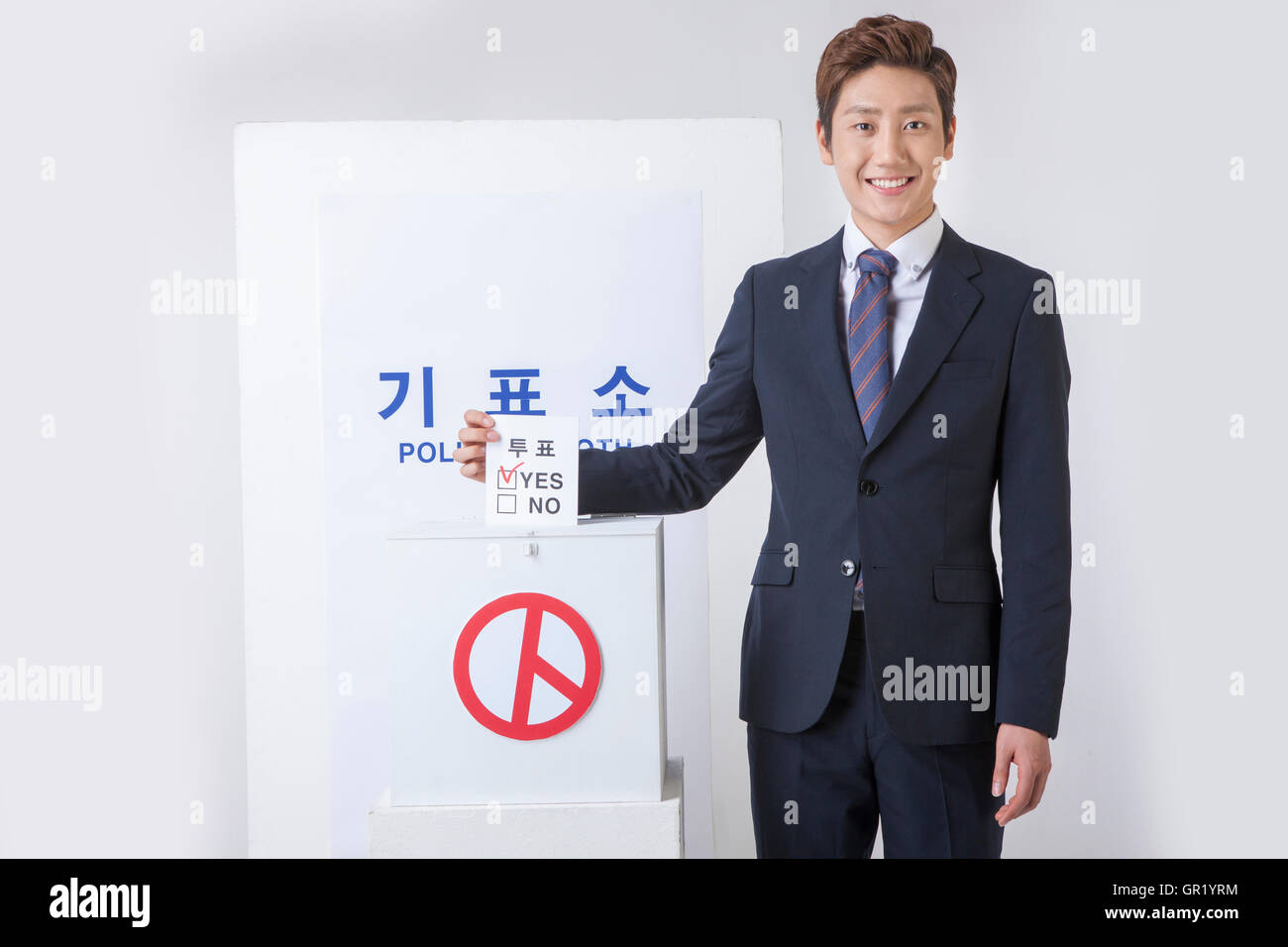Young smiling man in suit voting Stock Photo - Alamy