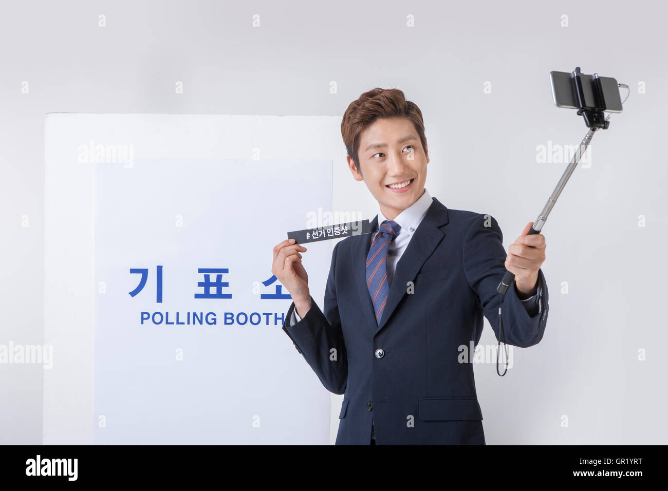 Young smiling man in suit taking selfie at voting booth Stock Photo - Alamy
