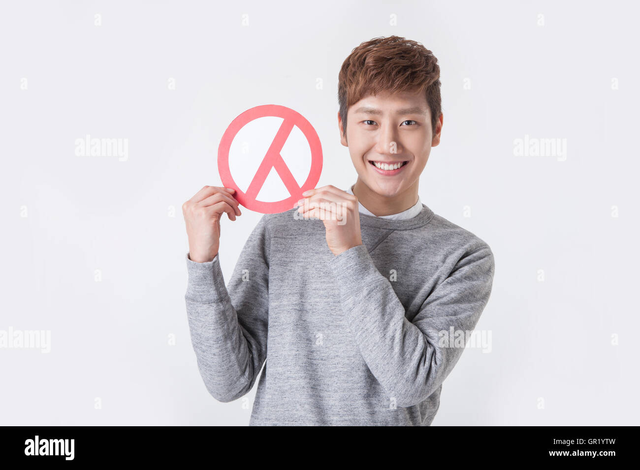 Portrait of young smiling man showing symbol of voting Stock Photo - Alamy