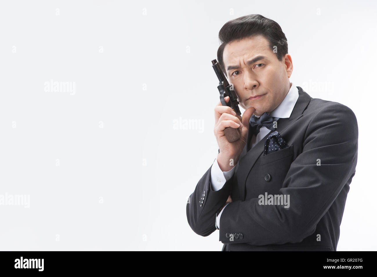 Man suit gun hi-res stock photography and images - Alamy