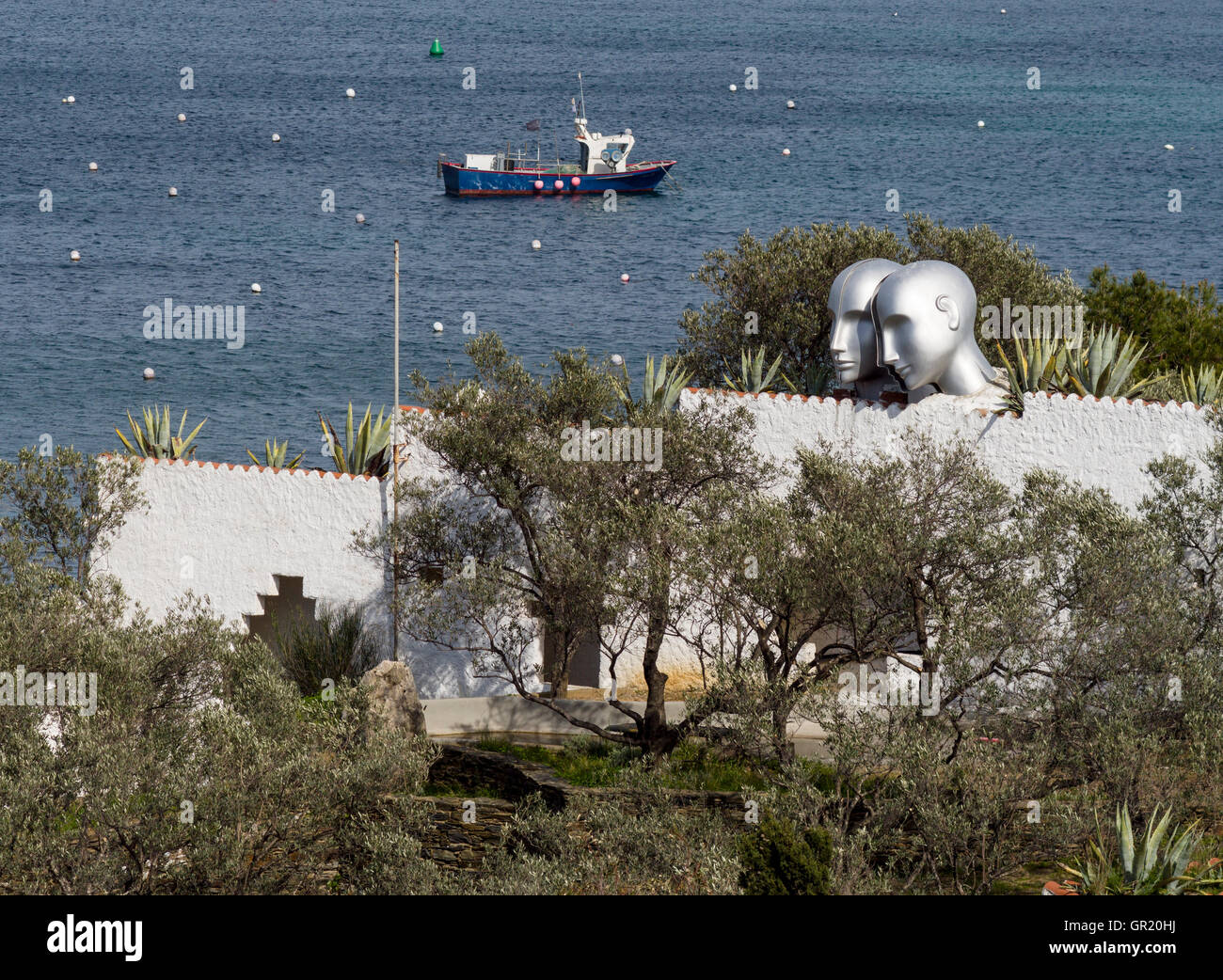 Tete a Tete above the wall to Salvador Dali House. A sculpture of pair ...