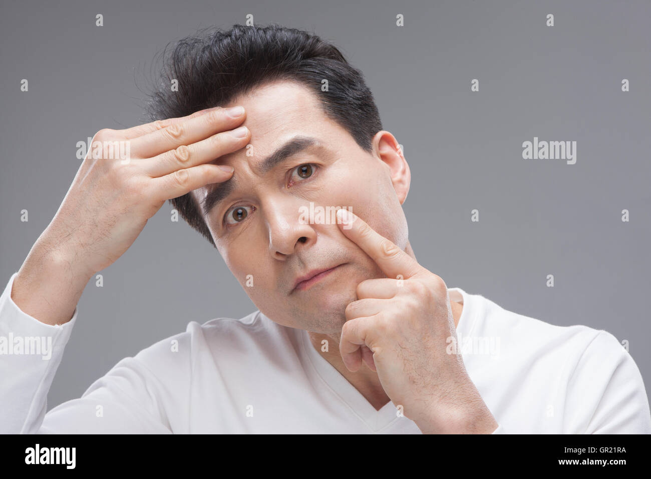 Man touching face hi-res stock photography and images - Alamy