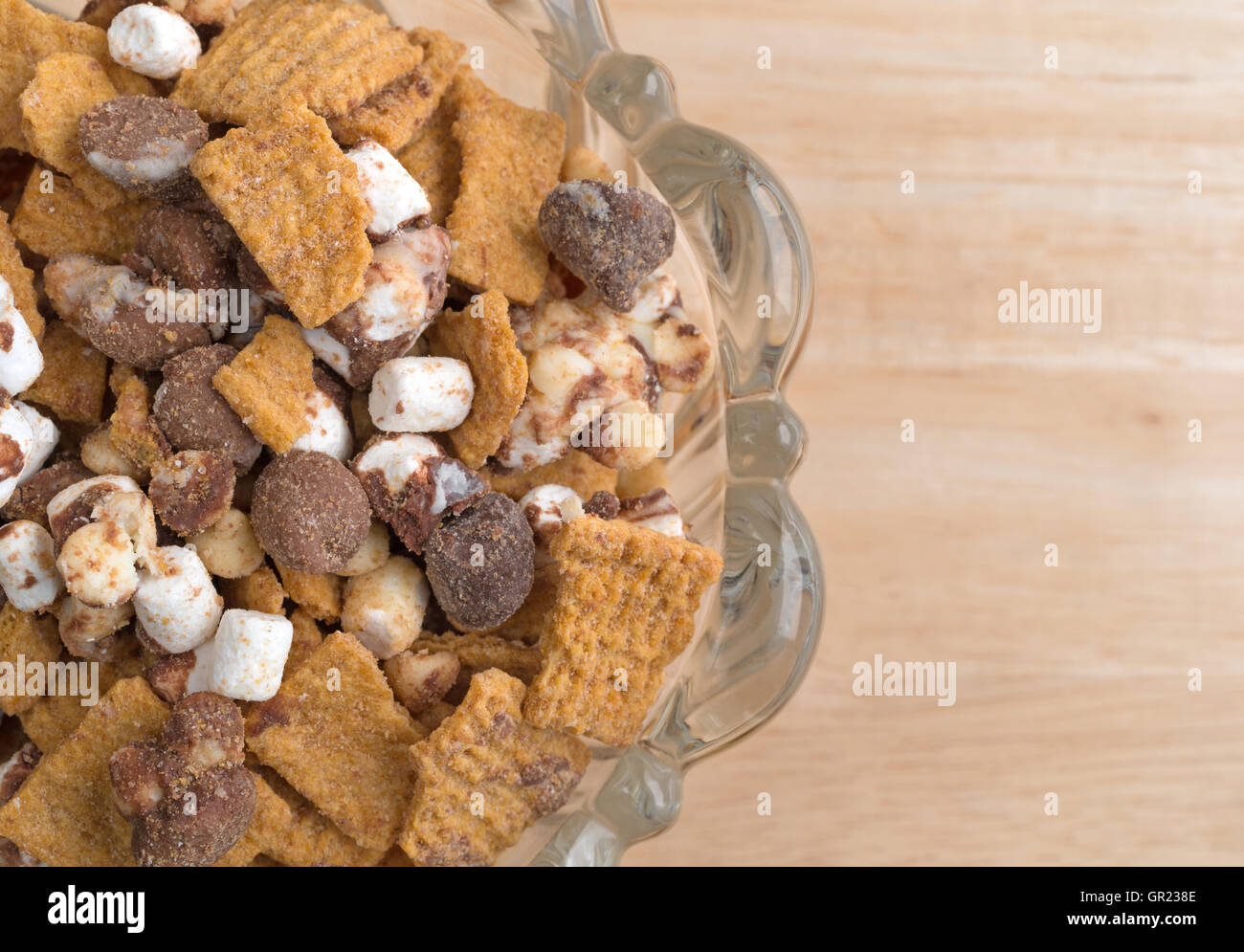 Top close view of smores candy mixture in a glass bowl on a wood table ...