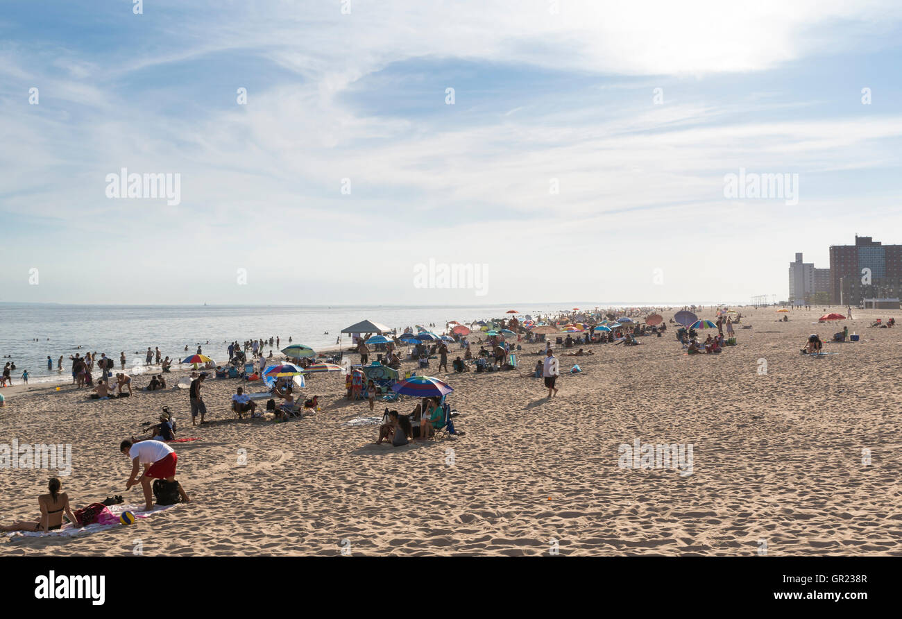 View of Coney Island beach with sunbathers and tourists in Summer Stock ...