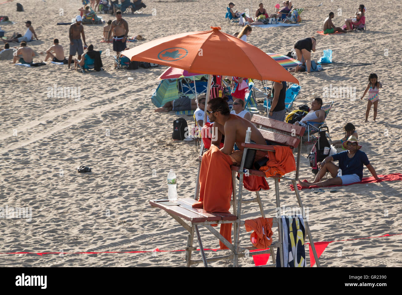 Man sitting in lifeguard chair hi-res stock photography and images - Alamy