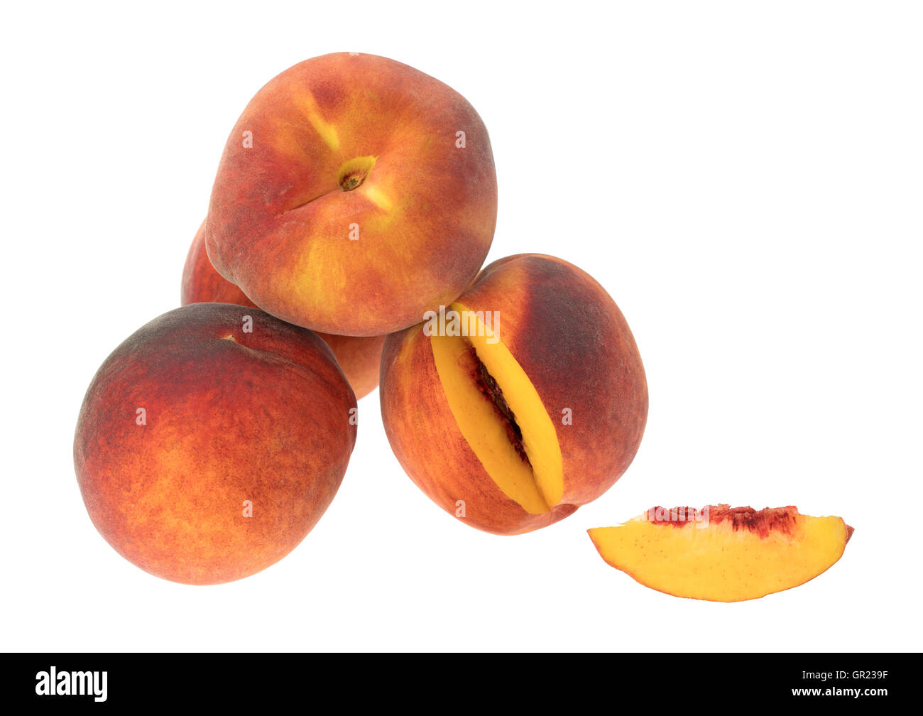 A group of whole nectarines with one slice removed from a fruit ...