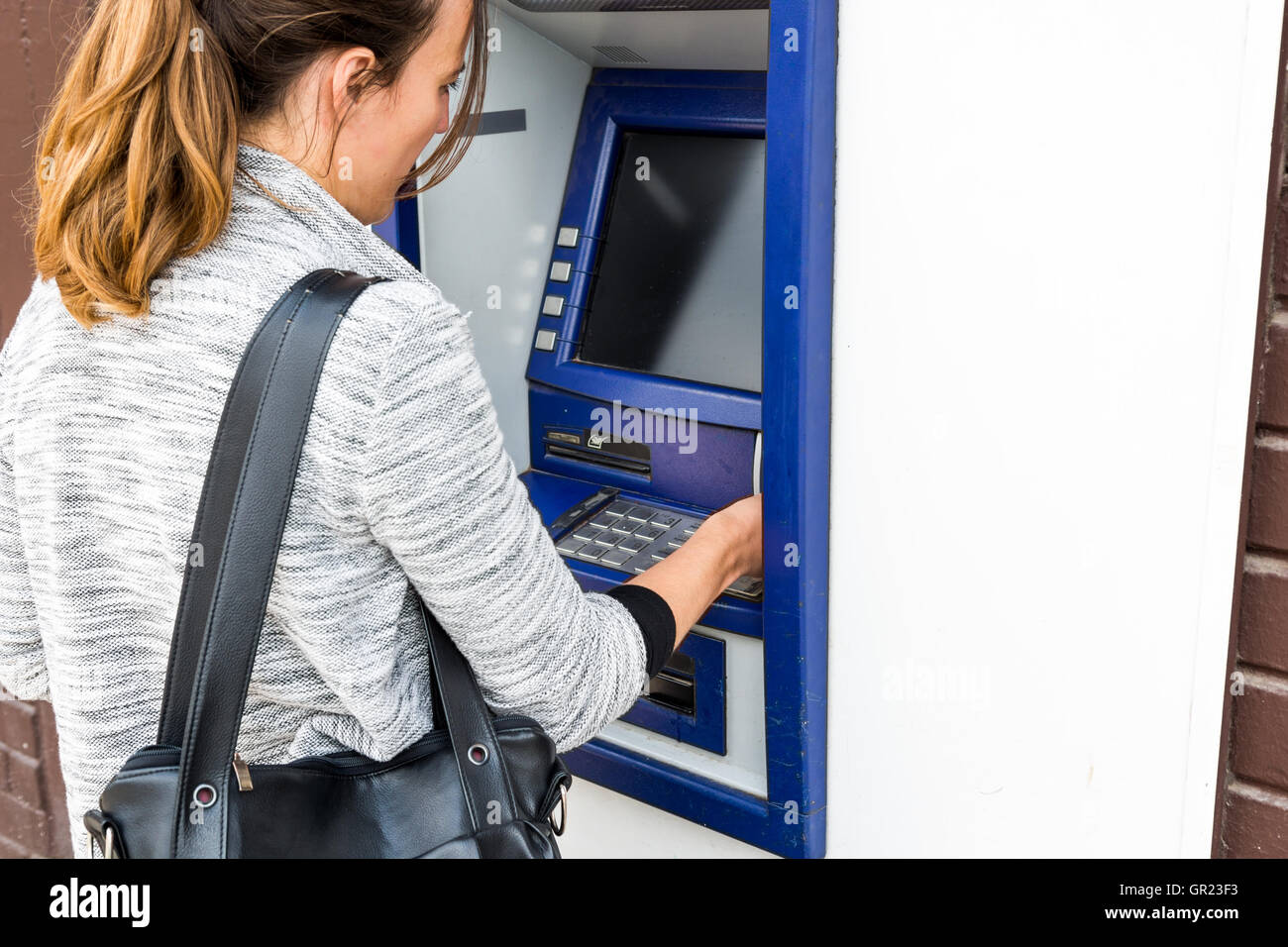 Student withdrawing cash at an atm hi-res stock photography and images ...