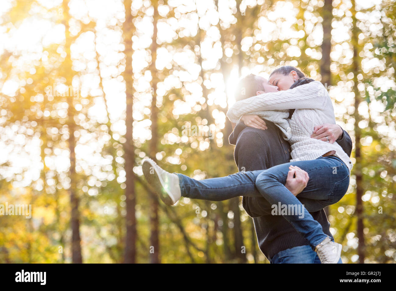 Couple in love, man carrying woman in his arms Stock Photo - Alamy