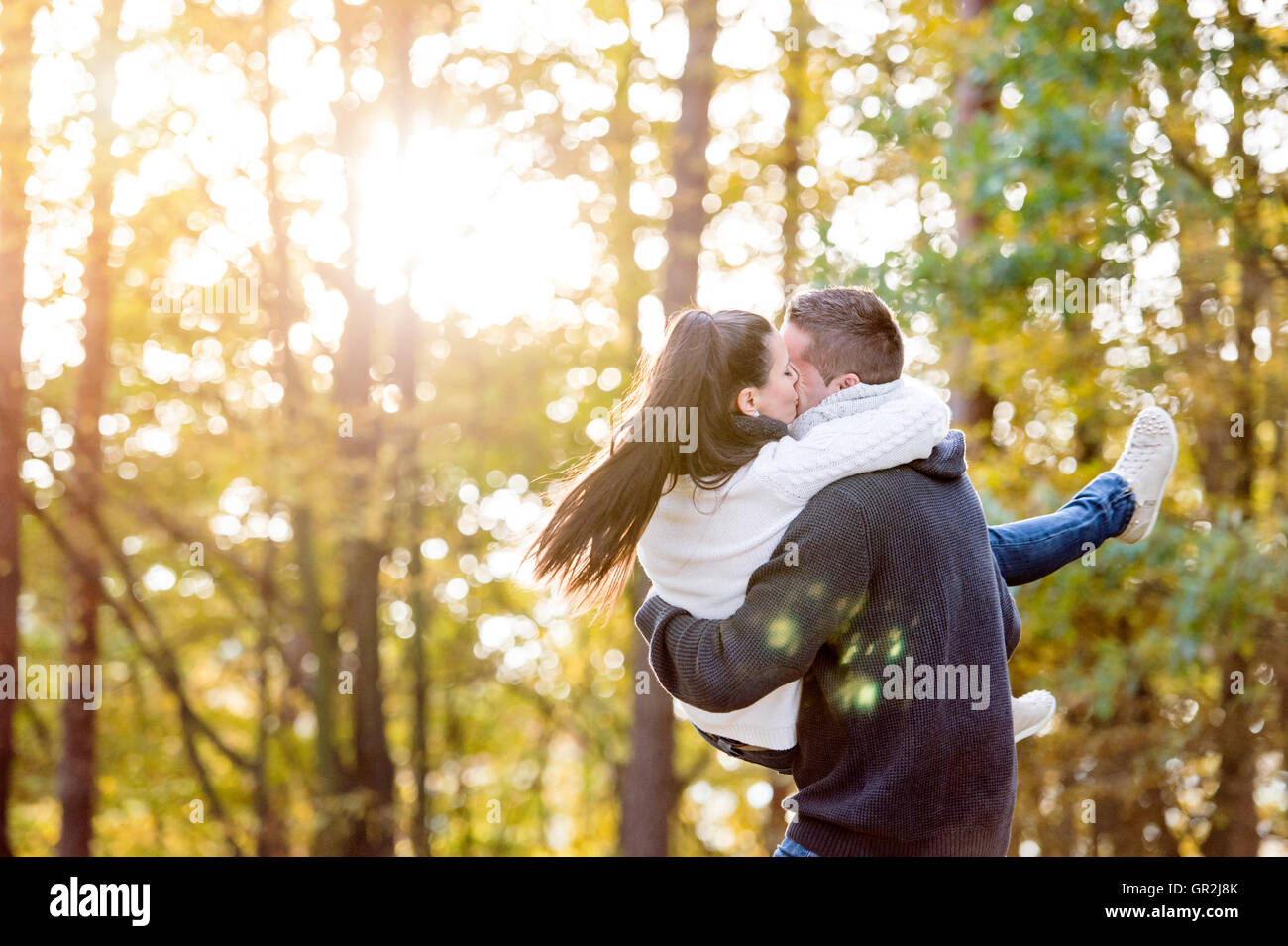 Couple in love, man carrying woman in his arms Stock Photo - Alamy