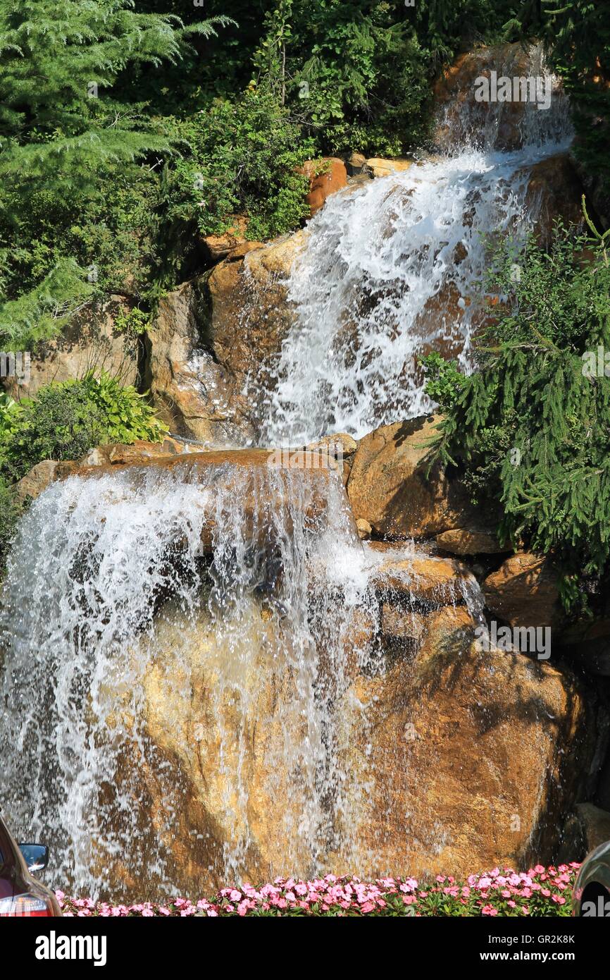 Waterfalls splashing about into the garden Stock Photo - Alamy