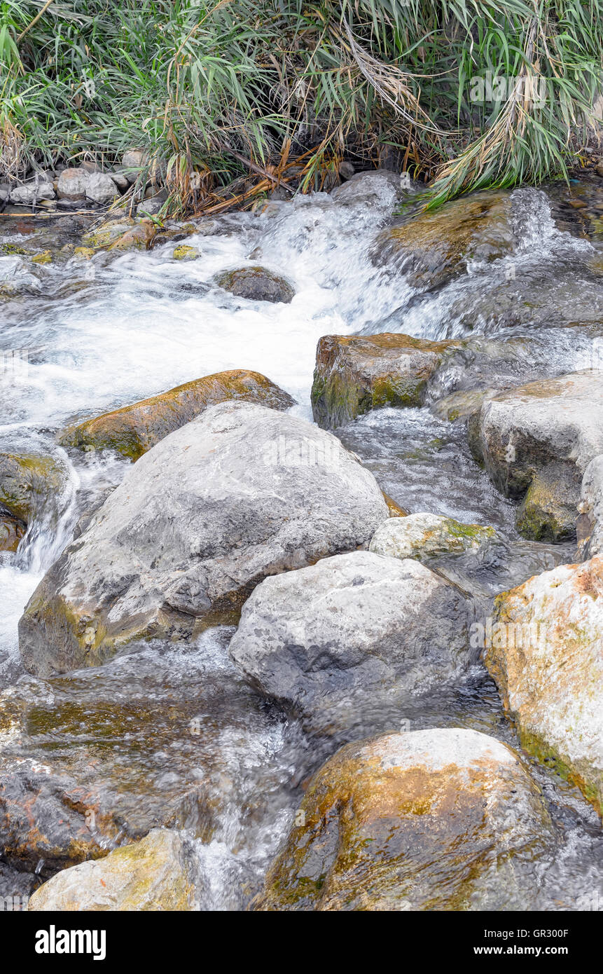 Nature background. Cloudy day. River with strong flow, through rocks ...