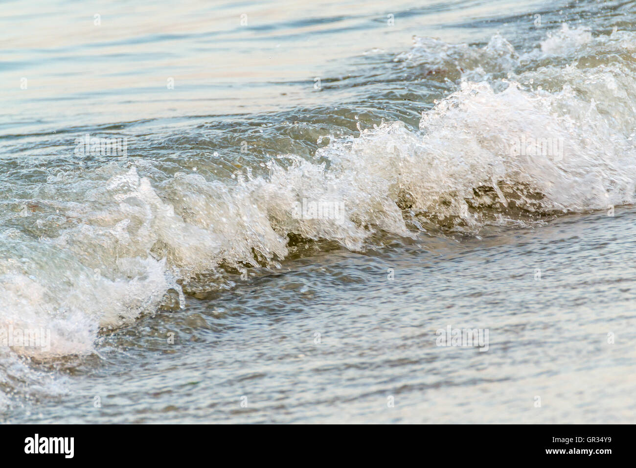 Water hitting shore Stock Photo - Alamy
