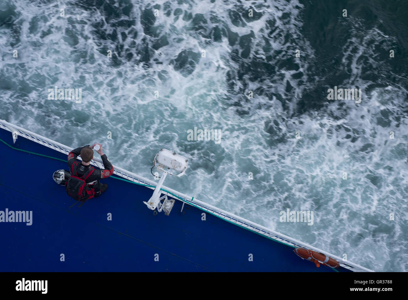 Looking down on a man looking down at the sea Stock Photo - Alamy