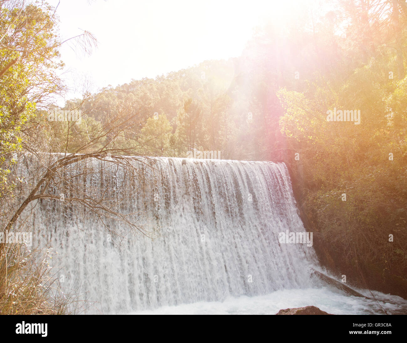 Waterfall with sunlight at the sunrise in the forest Stock Photo - Alamy