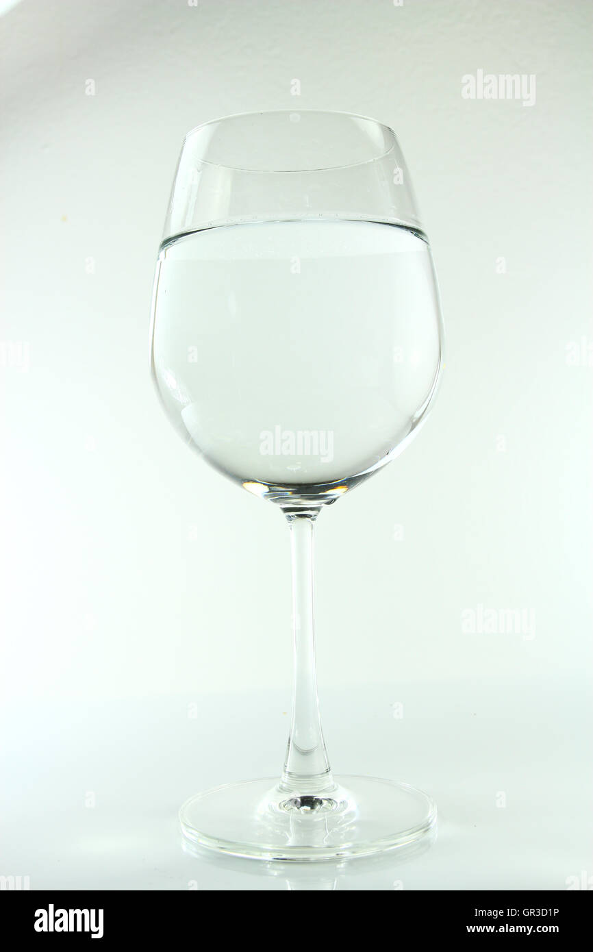 A full wine glass of water on a neutral background Stock Photo - Alamy