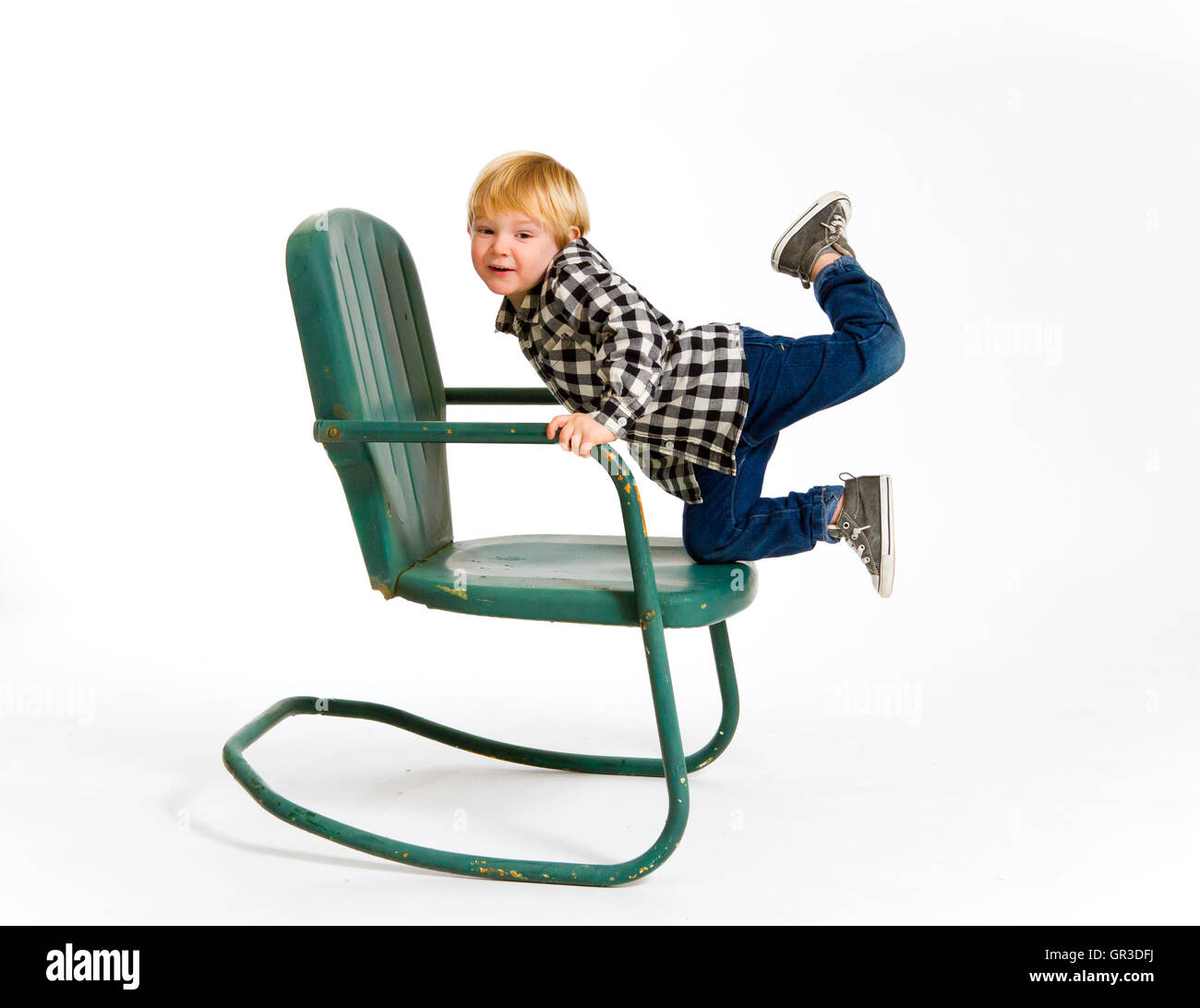 Boy Having Fun On Chair Stock Photo - Alamy