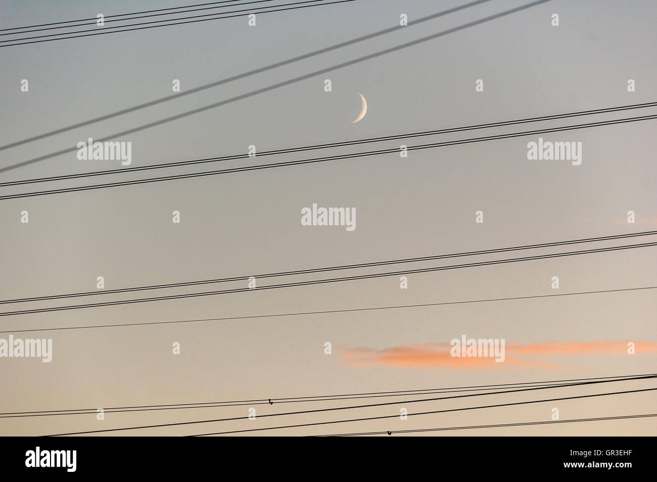 Power lines and crescent moon Stock Photo - Alamy