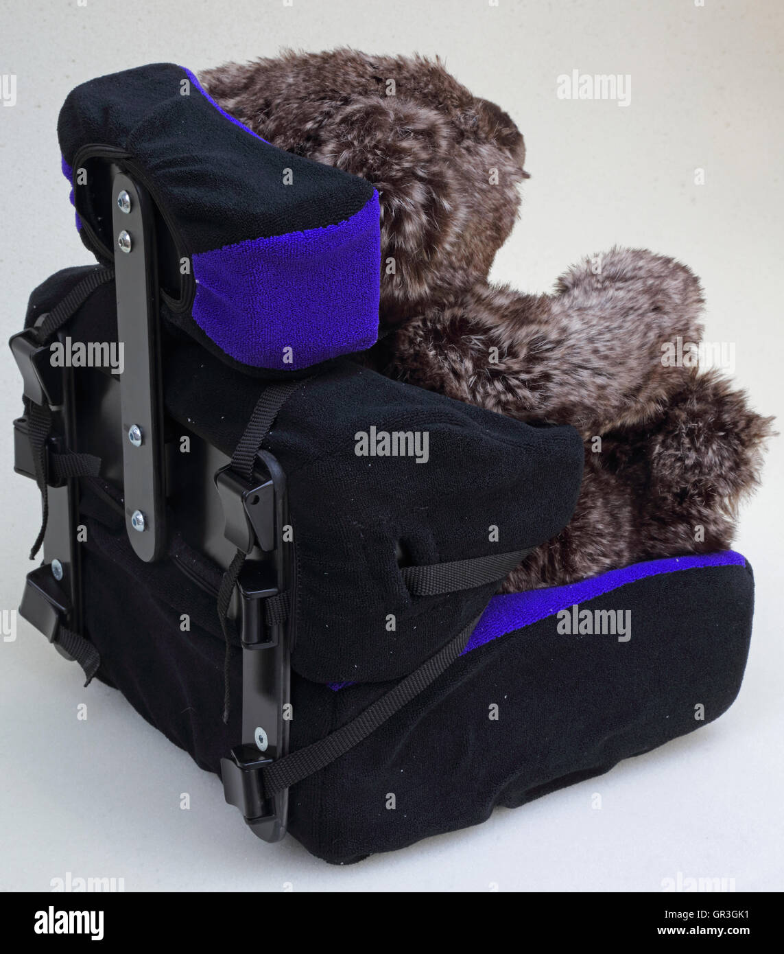 A cuddly Brown Teddy Bear sat and safely strapped and secured in a ...