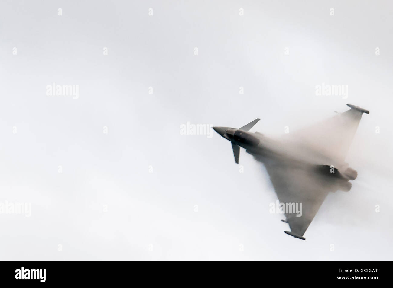 A condensation cloud forms over the wings of a Eurofighter Typhoon from ...