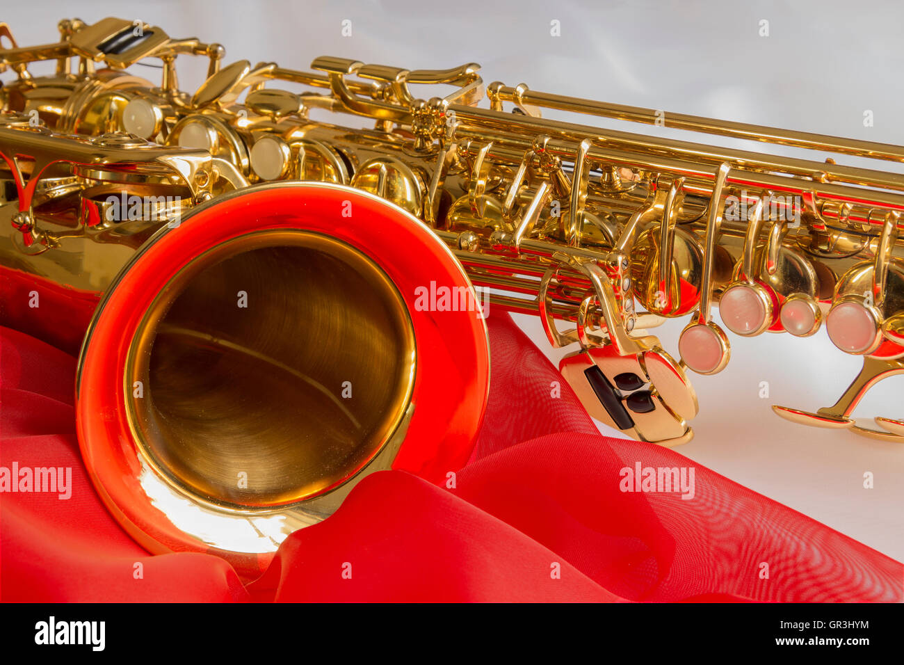 saxophone on a red silk Stock Photo - Alamy