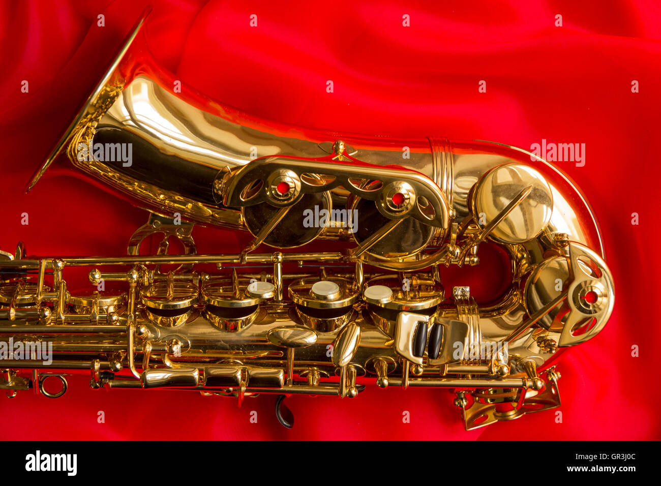 saxophone on a red silk Stock Photo - Alamy