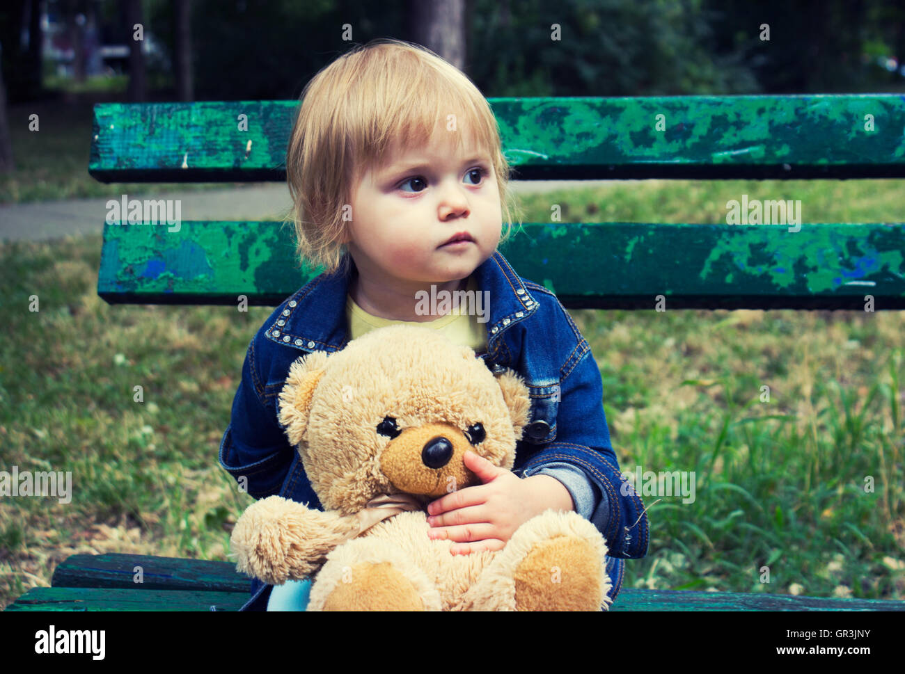 Baby girl sitting on bench hi-res stock photography and images - Alamy