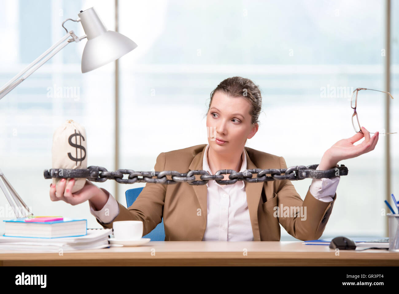 Woman chained working desk hi-res stock photography and images - Alamy
