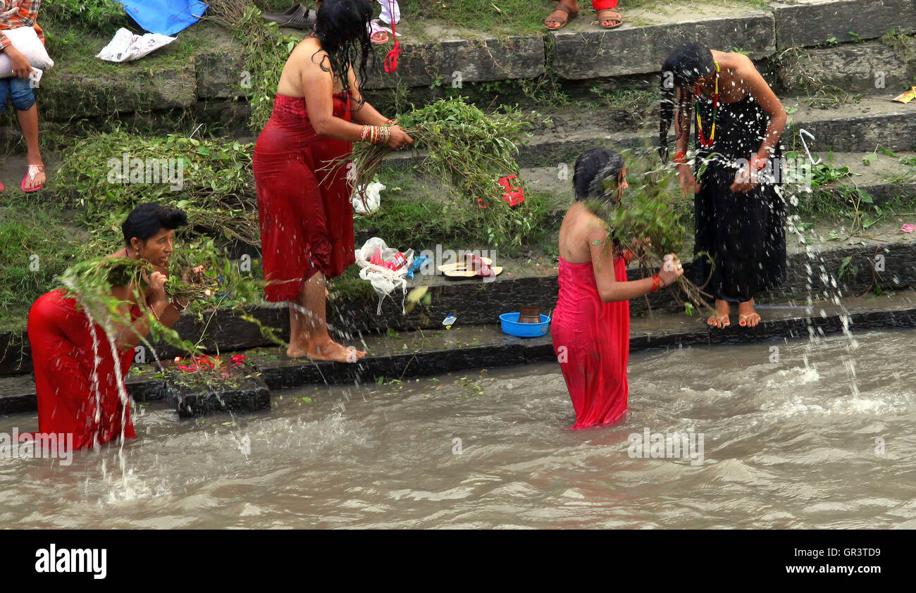 Kathmandu, Nepal. 06th Sep, 2016. Hindu women take a bath ritual by ...