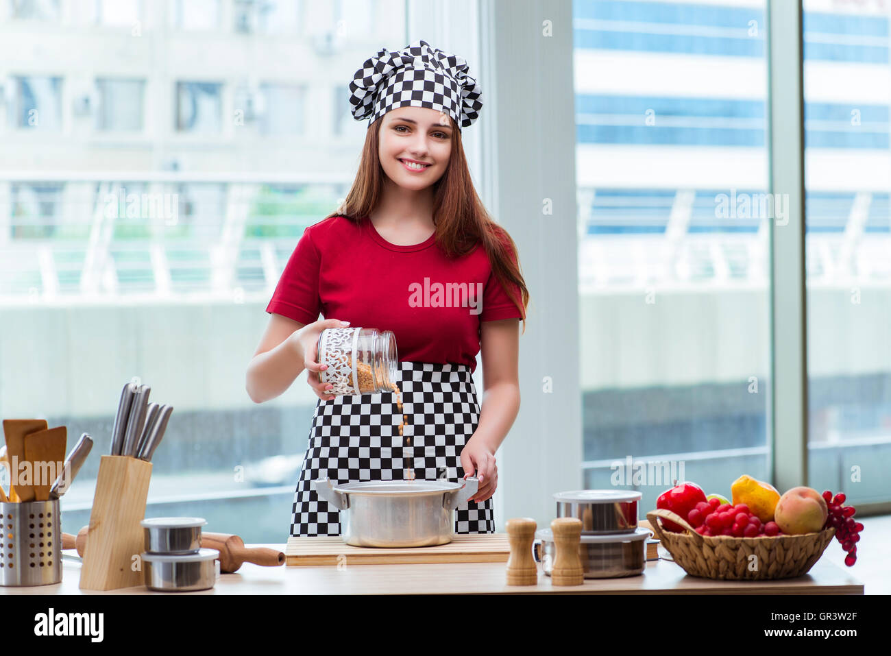 Young housewife preparing soup in kitchen Stock Photo - Alamy