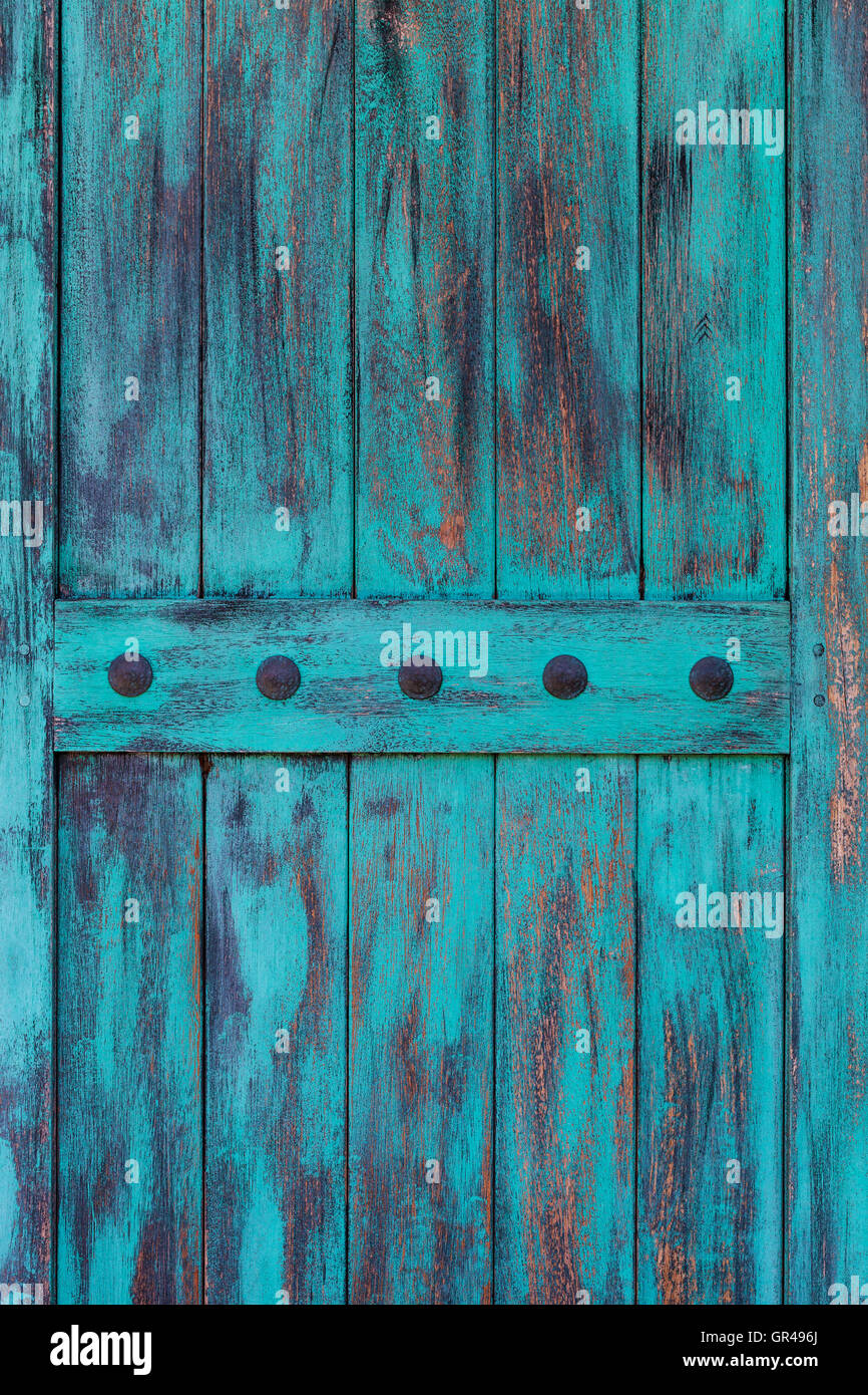 Rustic antique aqua blue wood door background with rusty iron bolts for ...