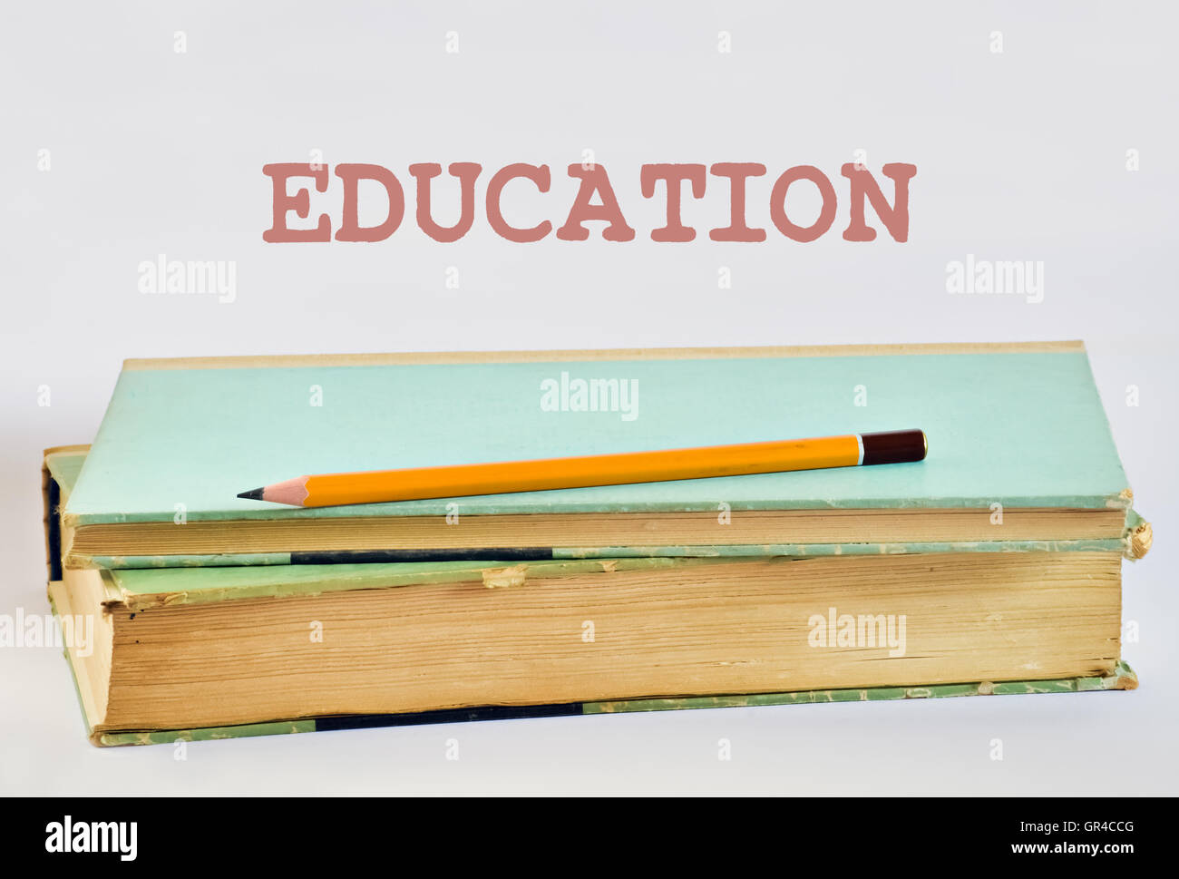 Two old books and word Education on bright background Stock Photo - Alamy