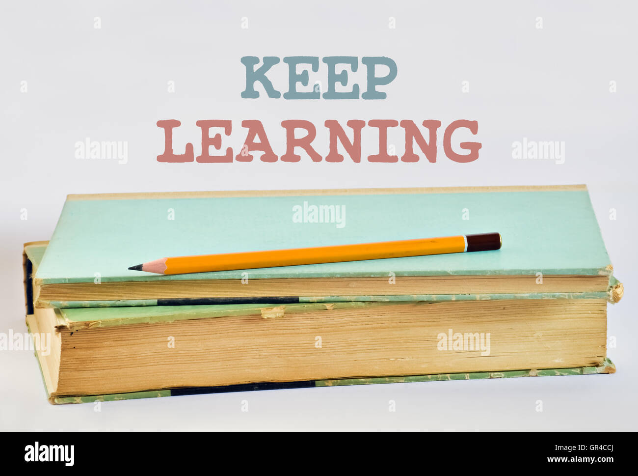 Two old books and text Keep Learning on bright background Stock Photo ...