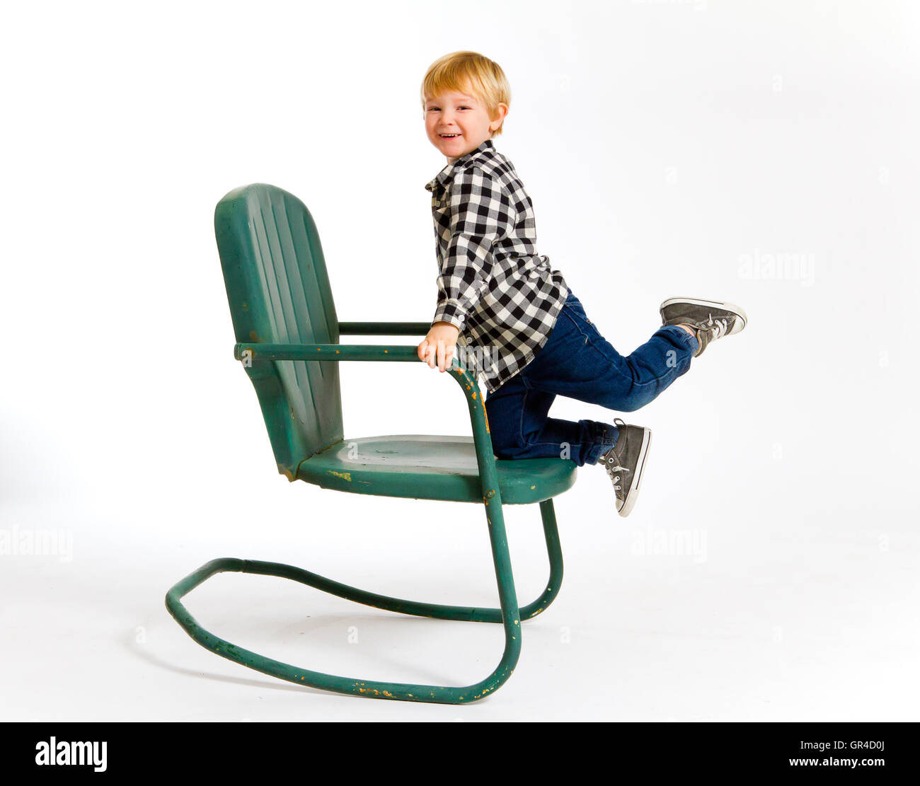 Boy Having Fun On Chair Stock Photo - Alamy
