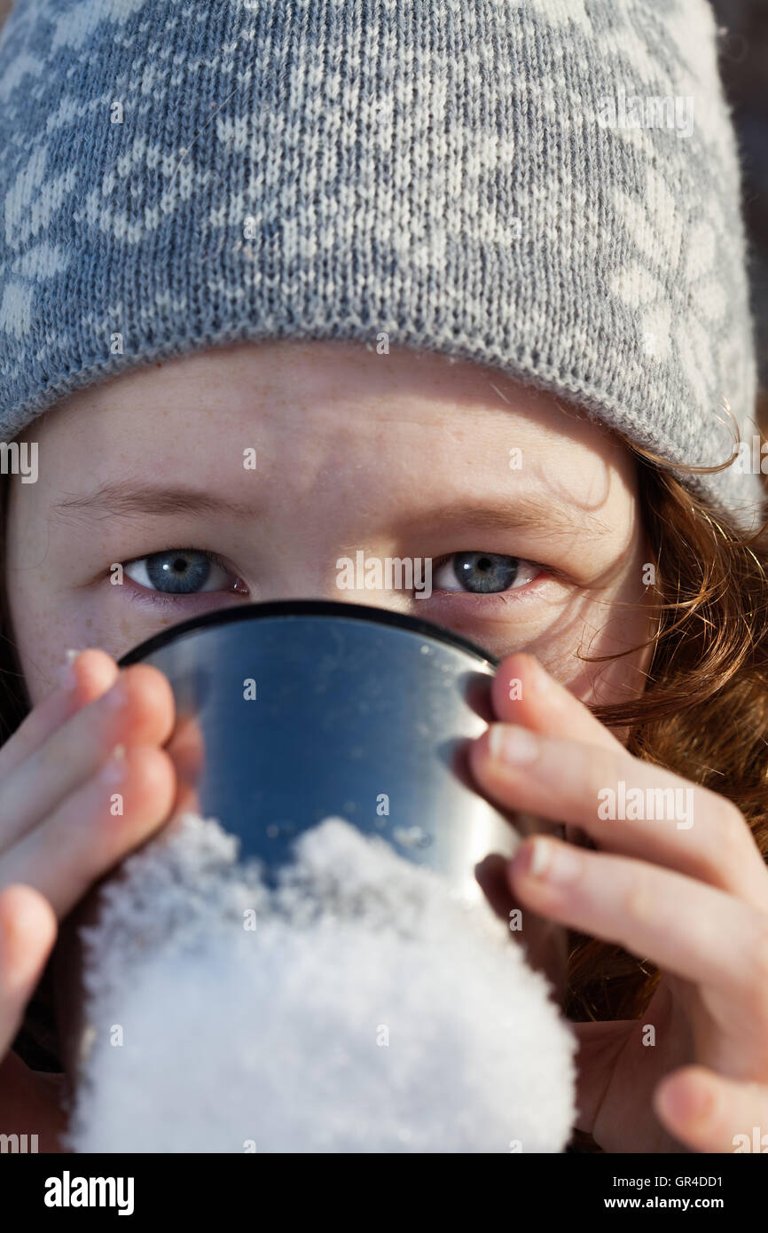 Girl drinking from flask cup Stock Photo - Alamy