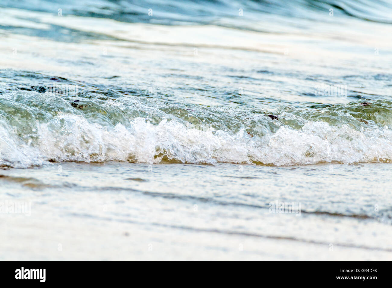 Water hitting shore Stock Photo - Alamy
