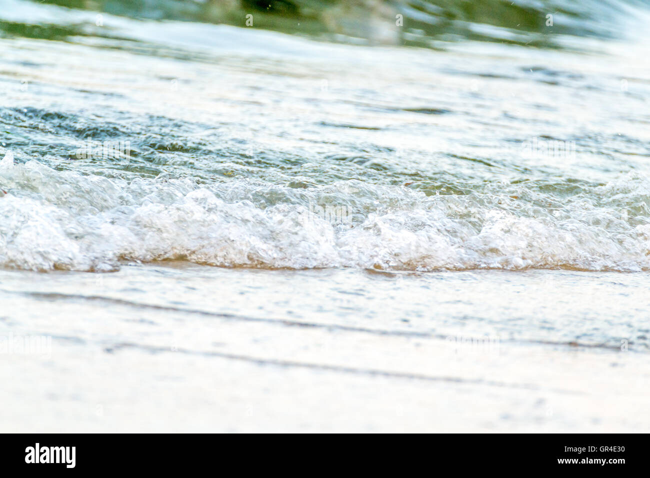 Water hitting shore Stock Photo - Alamy