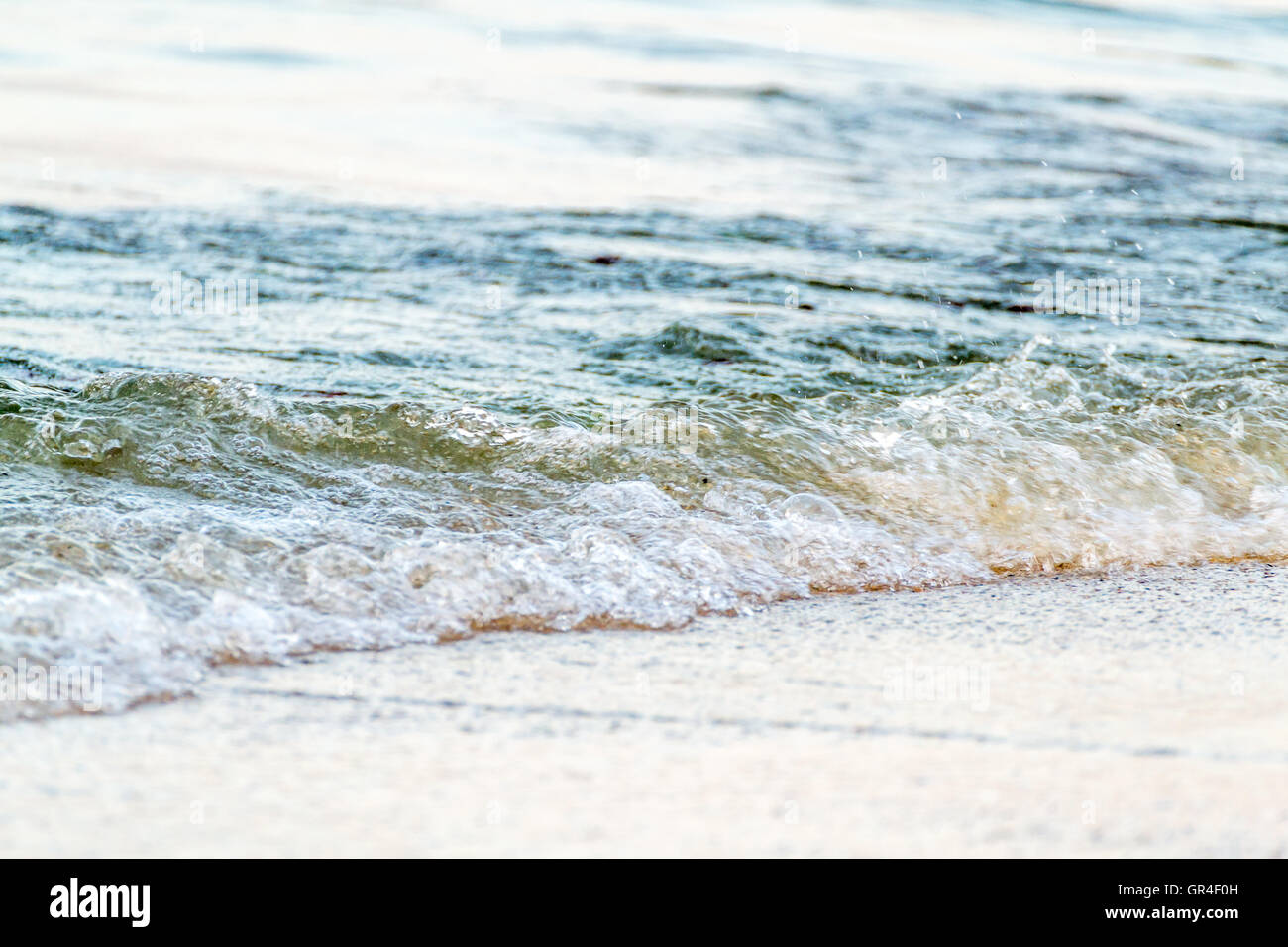Water hitting shore Stock Photo - Alamy
