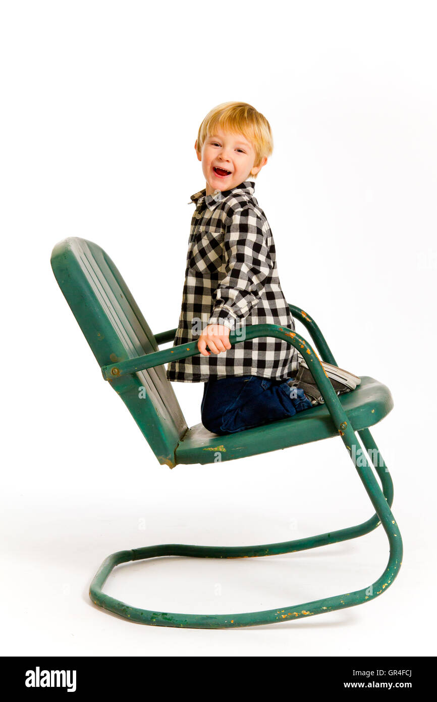 Boy Having Fun On Chair Stock Photo - Alamy