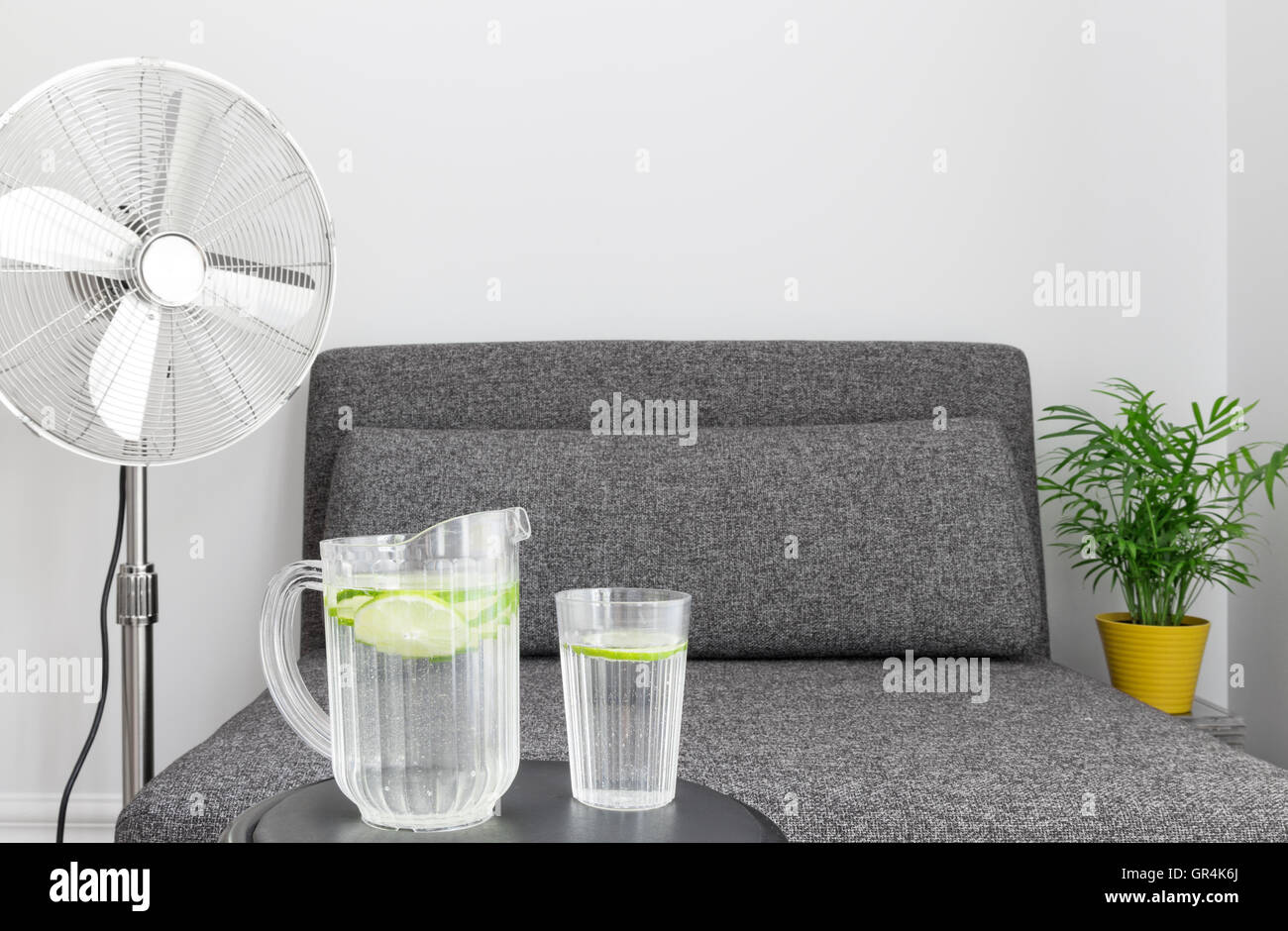 Electric fan and water to cool down Stock Photo - Alamy
