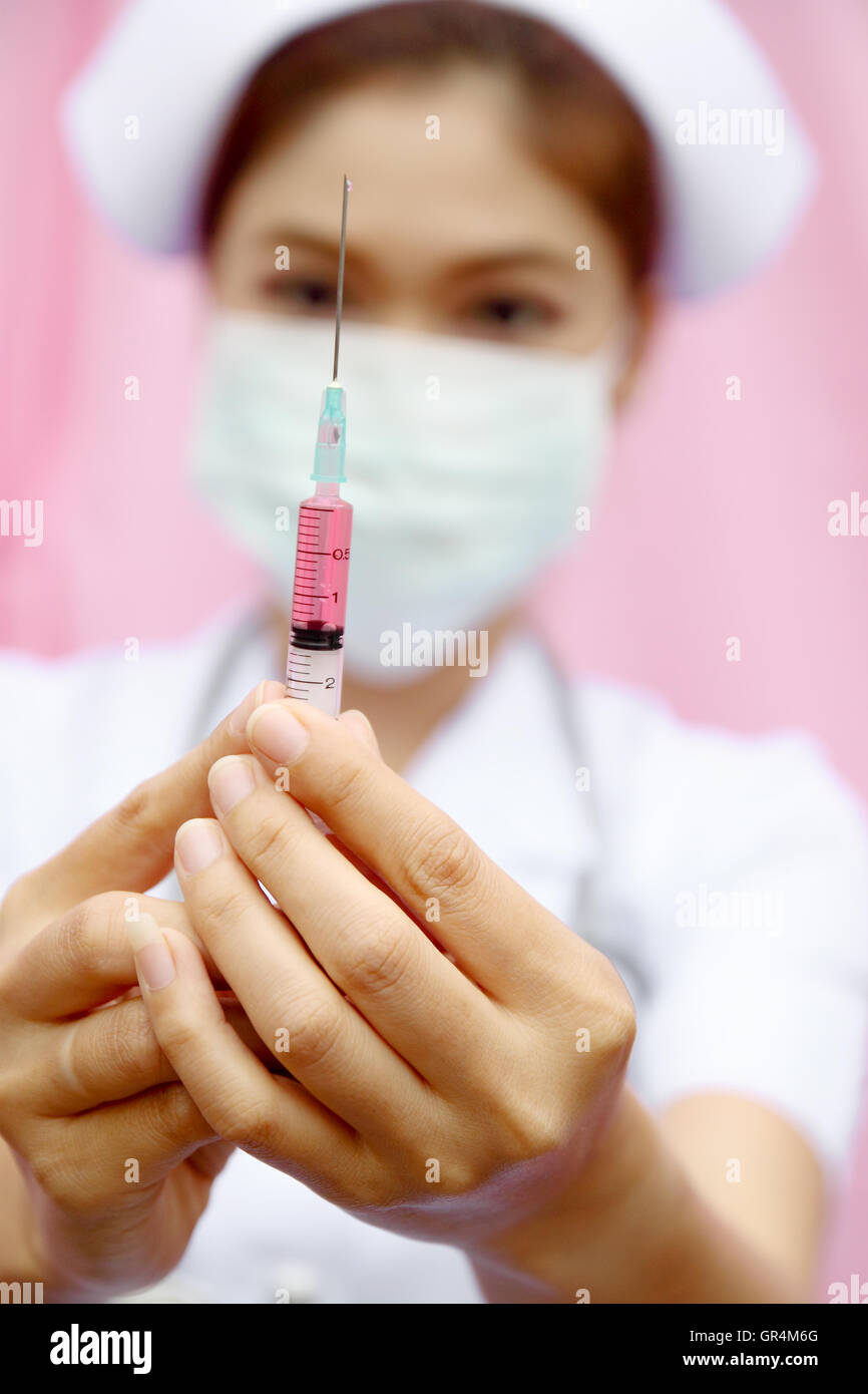 Nurse standing with syringe Stock Photo - Alamy
