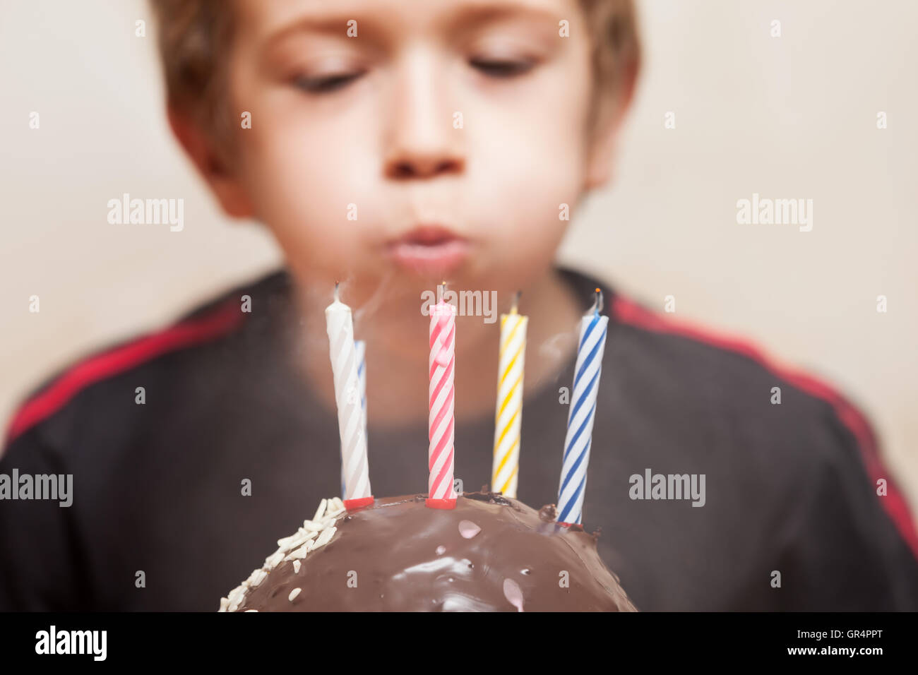 Smiling child with birthday cake candle Stock Photo - Alamy
