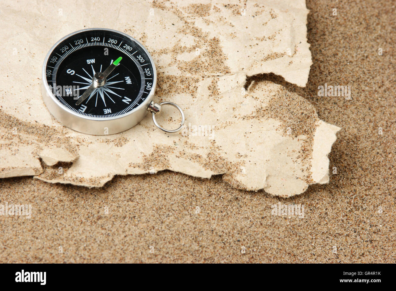 Compass on old sheet paper against the background of sand Stock Photo ...