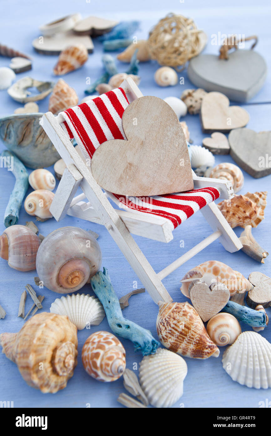 Striped beach chair and sea shells Stock Photo - Alamy
