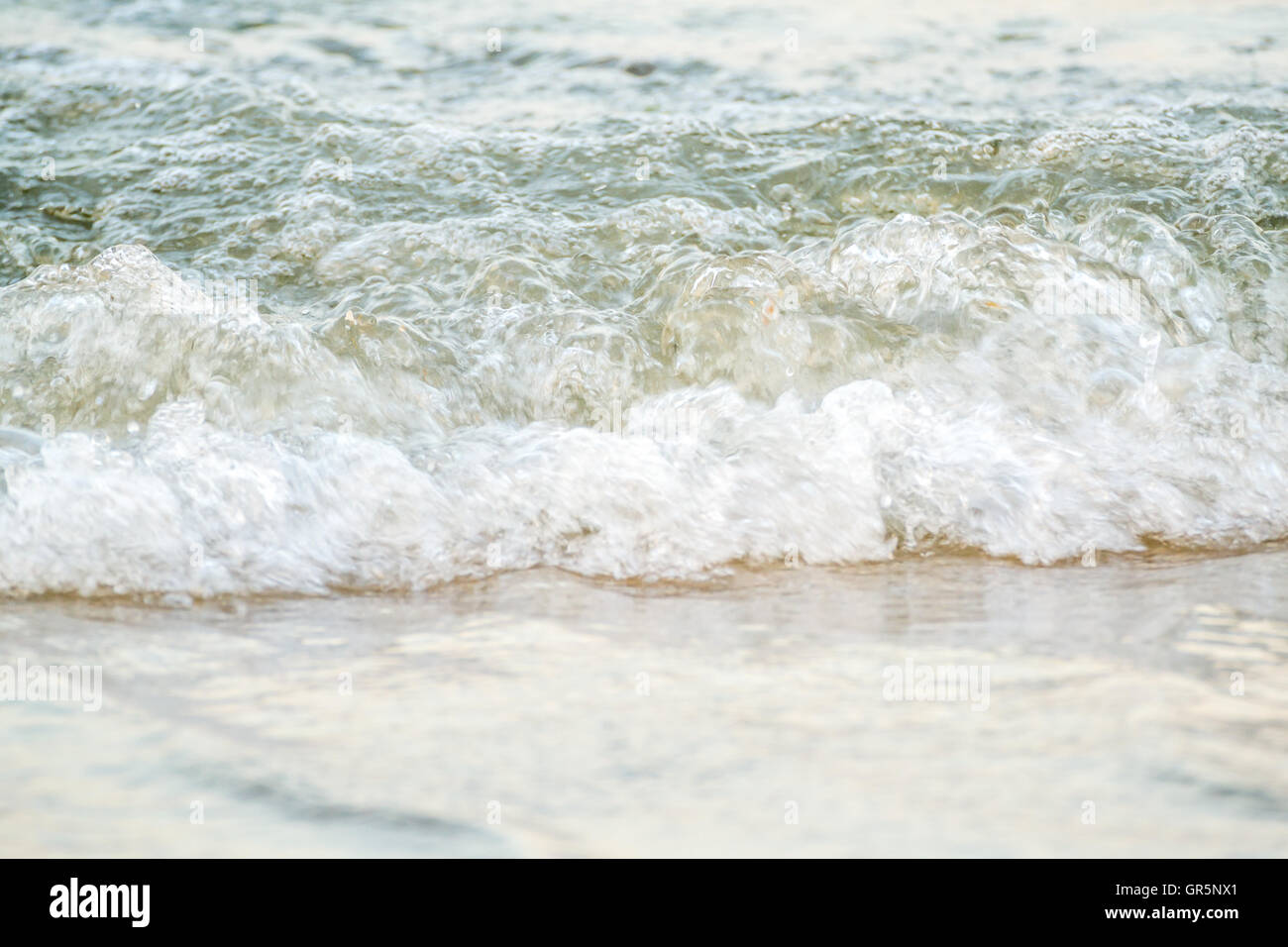 Water hitting shore Stock Photo - Alamy