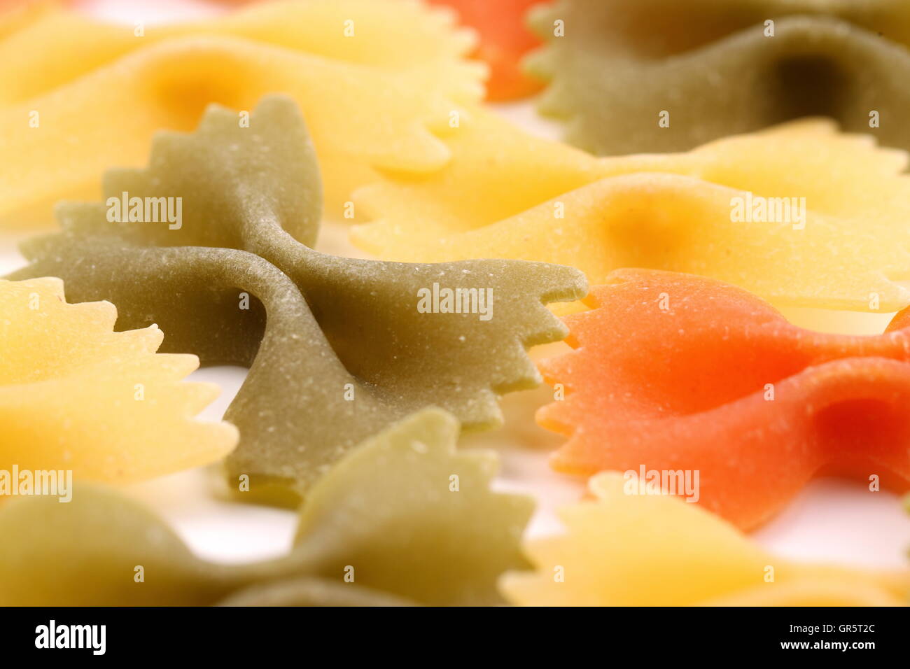 Farfalle pasta three colors close-up Stock Photo - Alamy