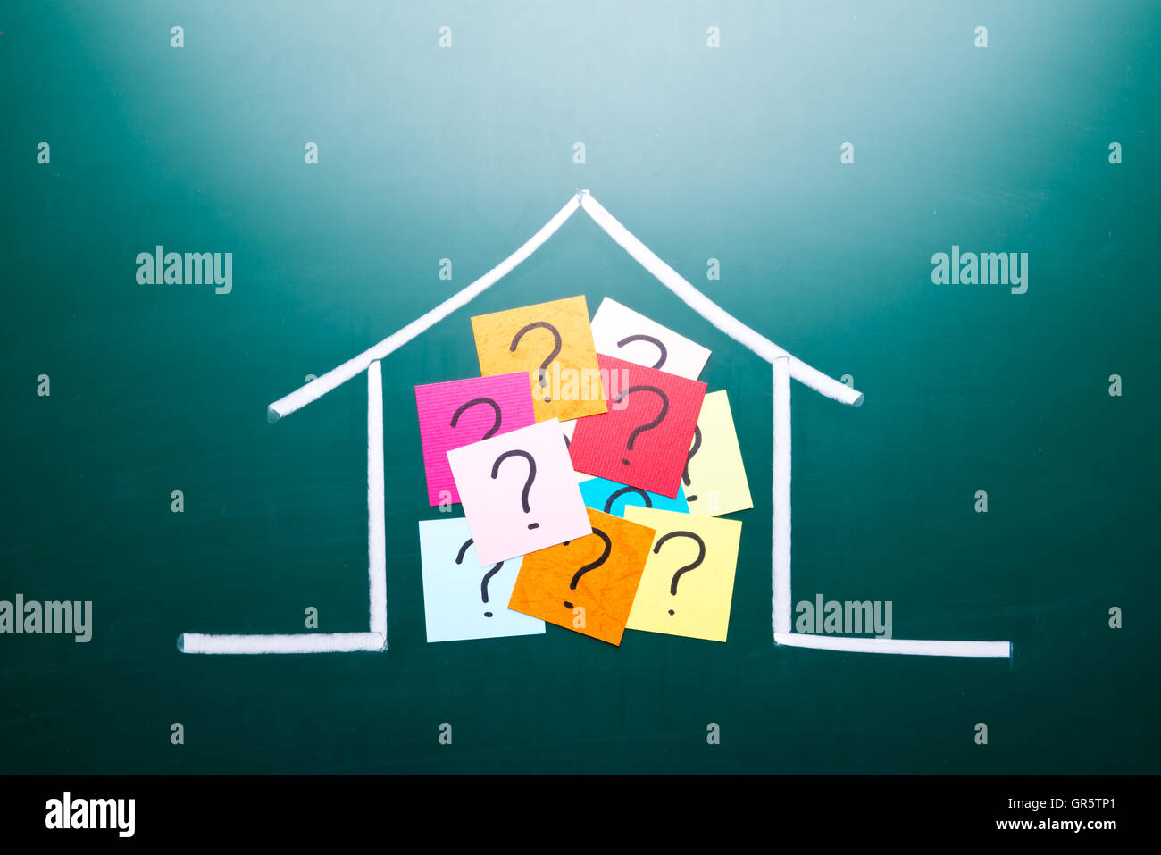 Color question mark in drawing house Stock Photo - Alamy