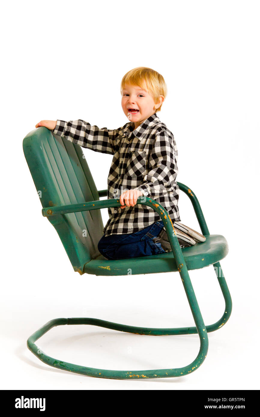 Boy Having Fun On Chair Stock Photo - Alamy